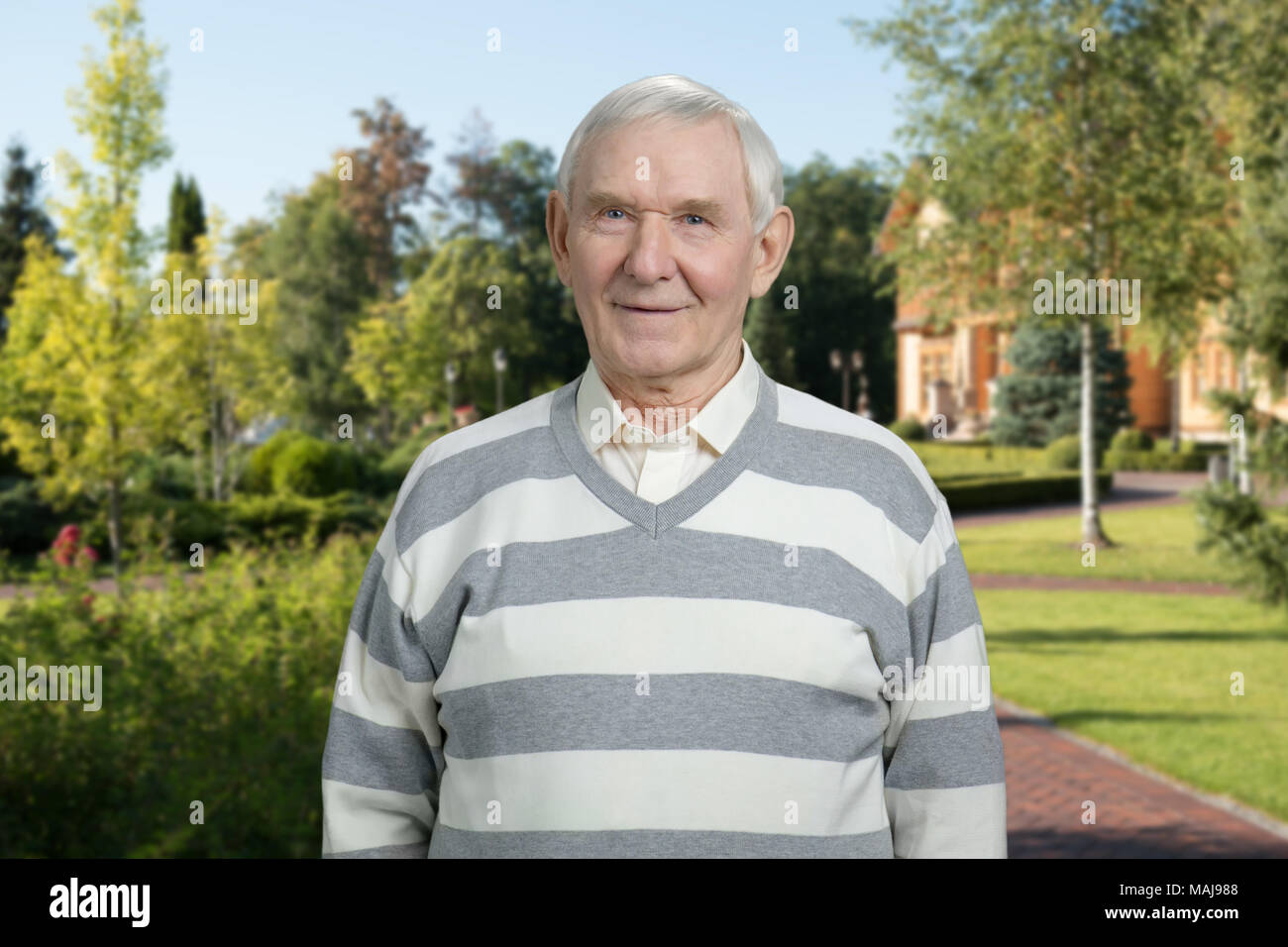 Portrait of smiling grandfather outdoor. Old wrinkled man with ...