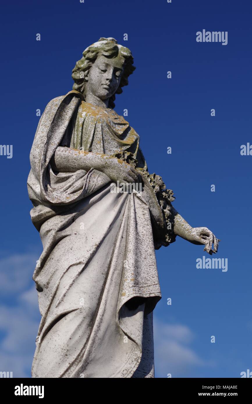 Victorian Angel Cherub Headstone Carving against a Blue Sky. Trinity ...