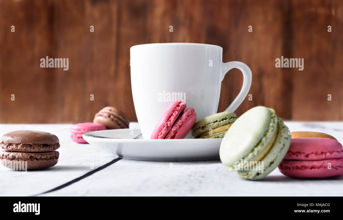 Delicious macaroons or macaron biscuits and coffee cup. Coffee break ...