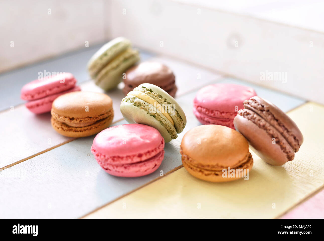 Delicious macaroons or macaron biscuits on a tablet. Coffee break scene ...