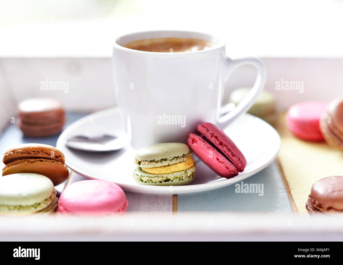 Delicious macaroons or macaron biscuits and coffee cup. Coffee break ...