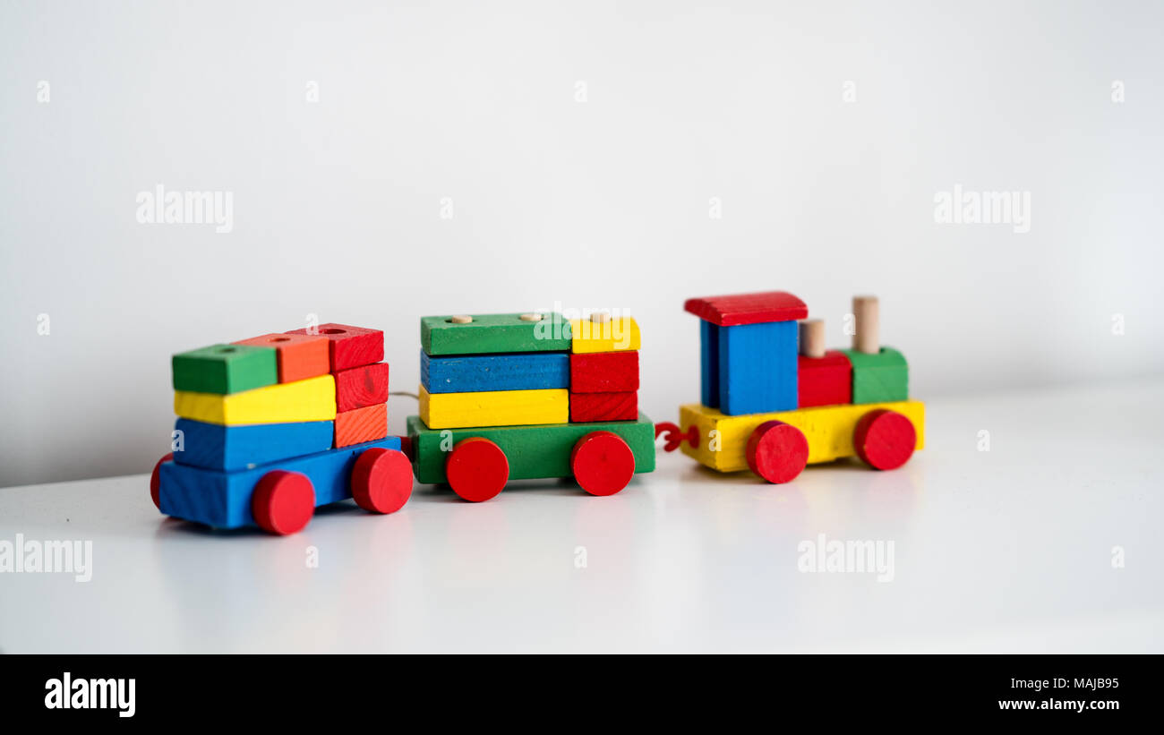 baby wooden toy train set on white background. colorful Stock Photo - Alamy