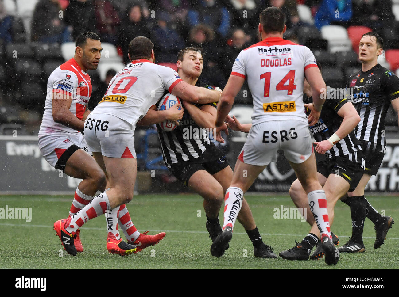 Widnes Vikings' Sam Wilde is tackled by St Helens' Kyle Amor during the ...