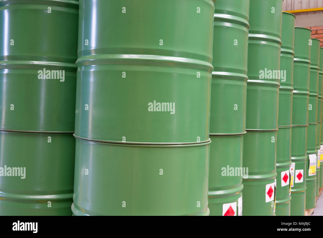 Green barrels or chemical drums stacked up Stock Photo - Alamy