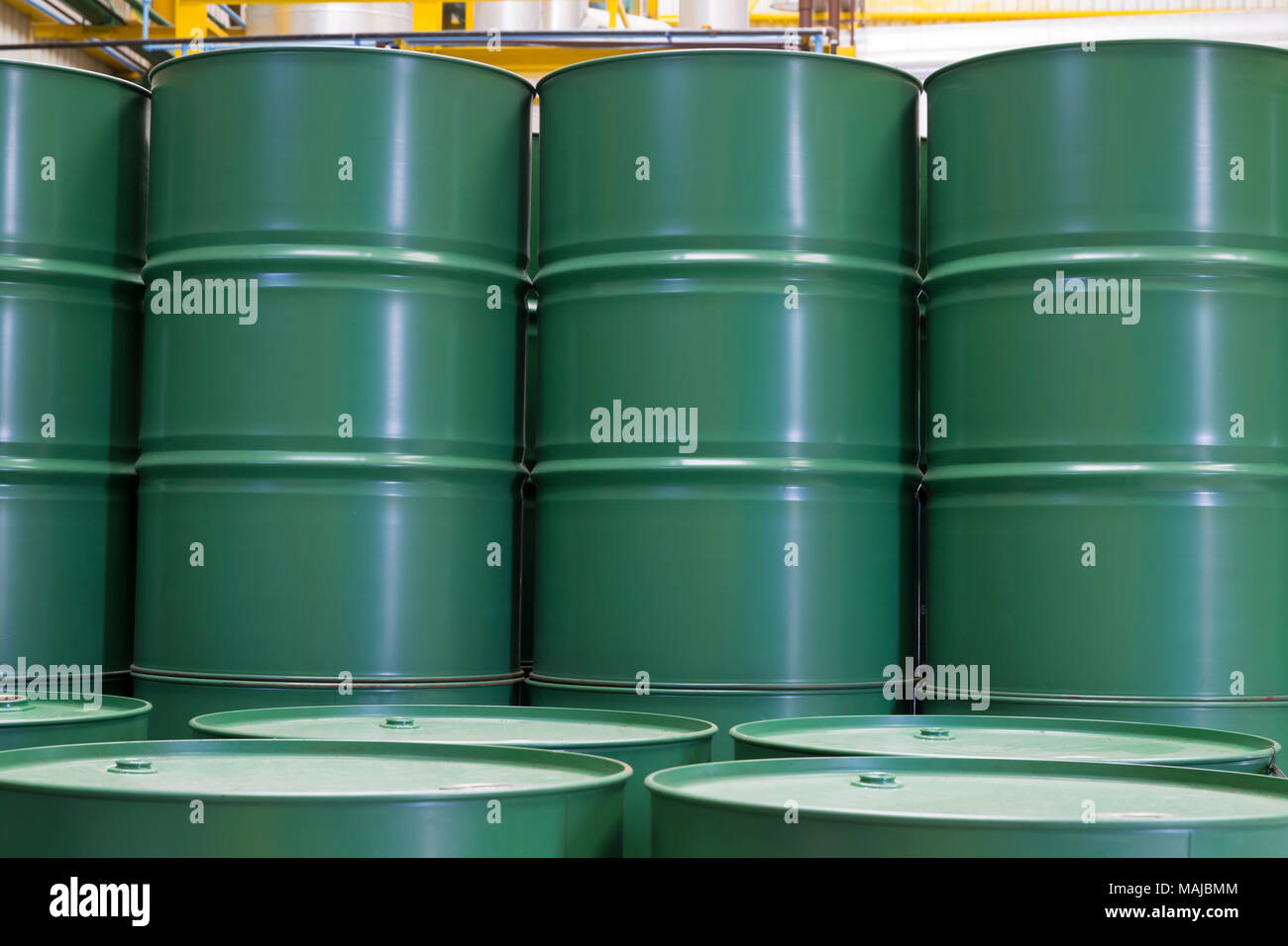 Green barrels or chemical drums stacked up Stock Photo - Alamy