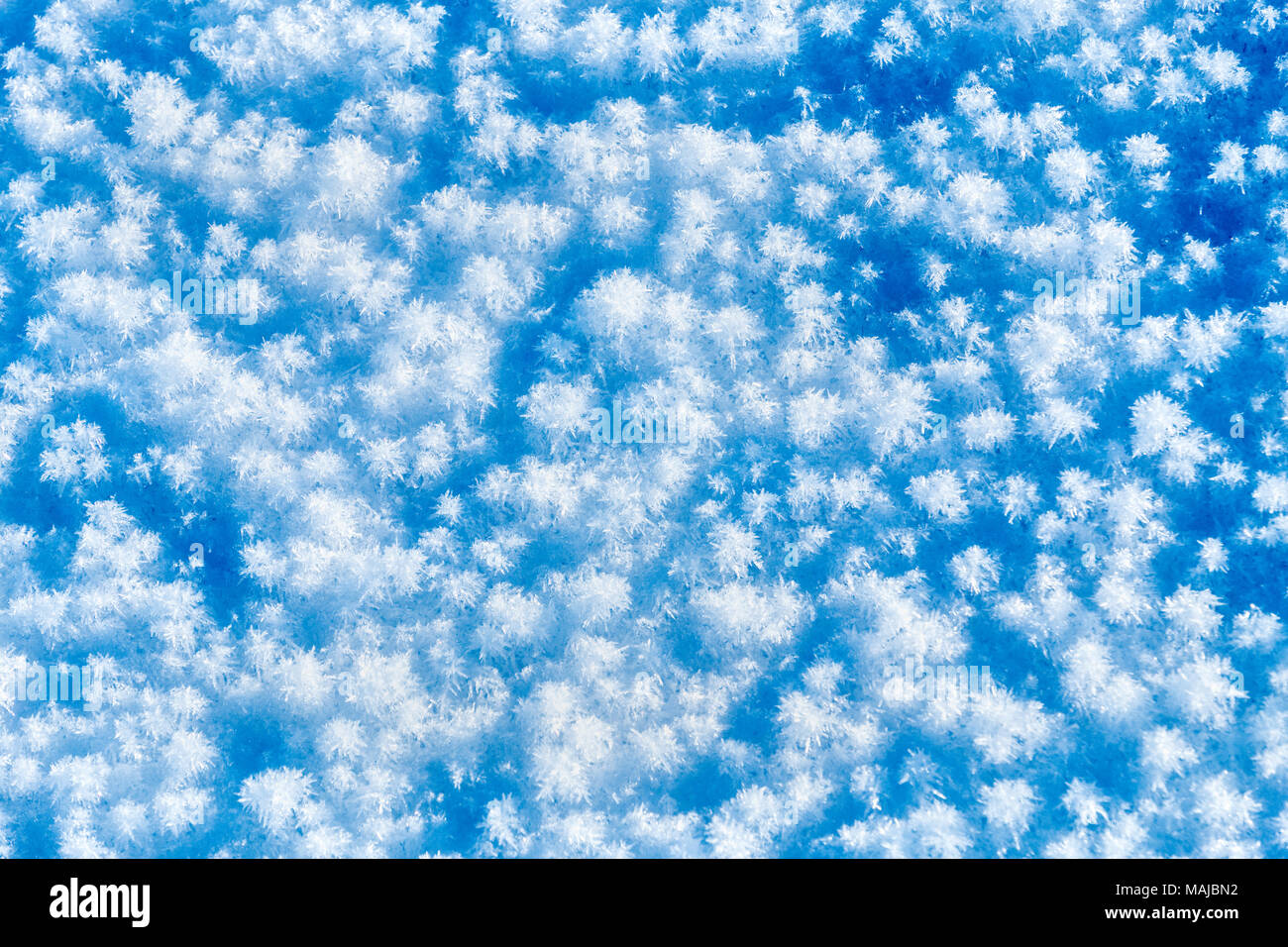 snow crystals on blue ice Stock Photo - Alamy