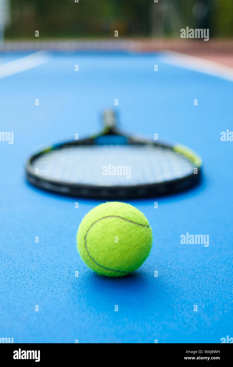 Yellow ball is laying on professional tennis racket background. A ball ...