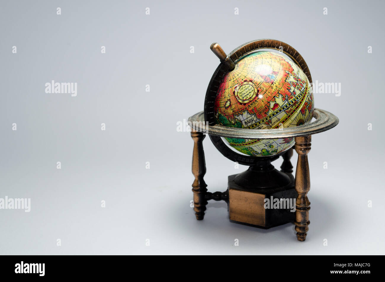 colored mini earth globe in a copper structure referring to navigations ...