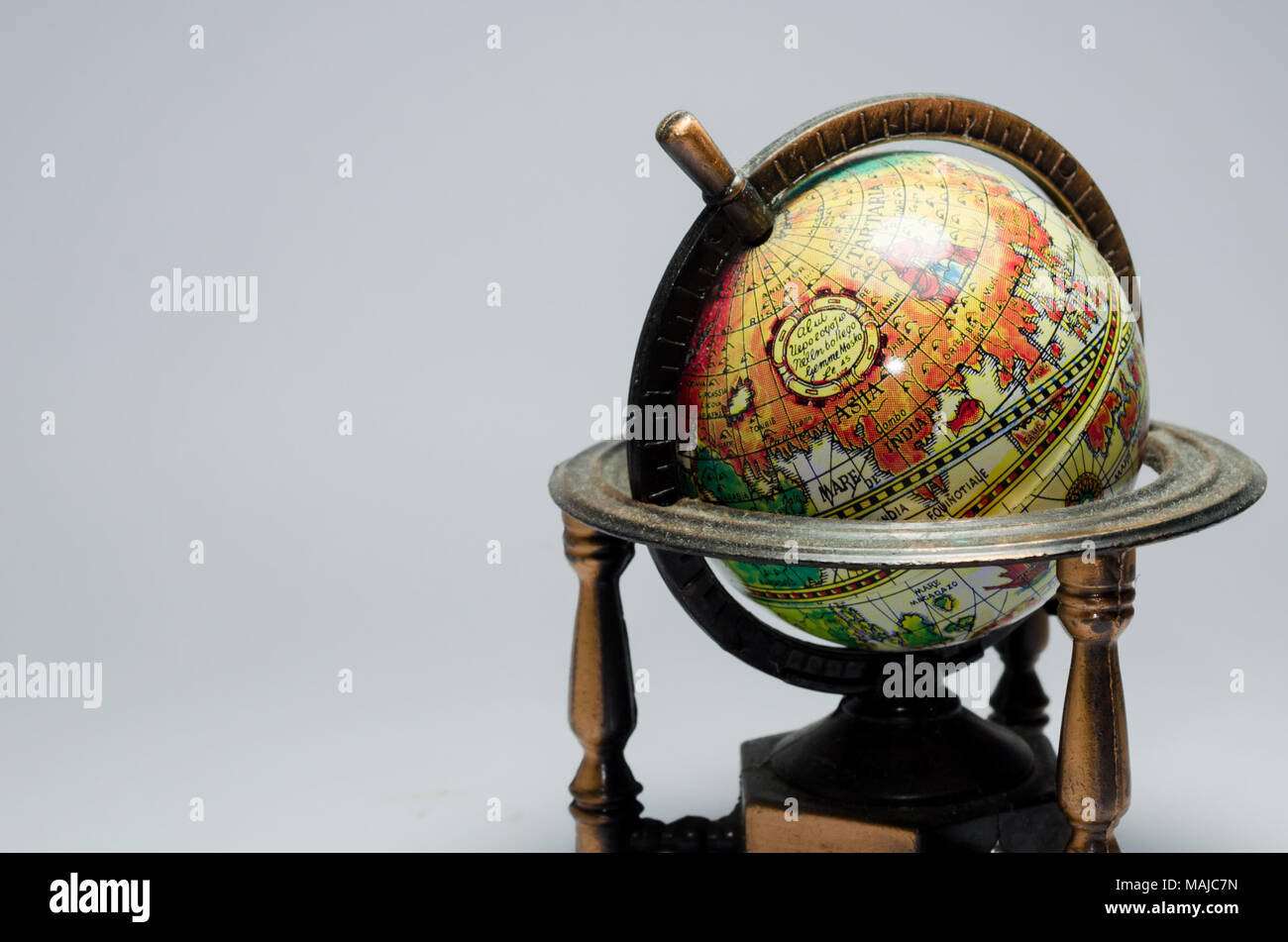 colored mini earth globe in a copper structure referring to navigations ...