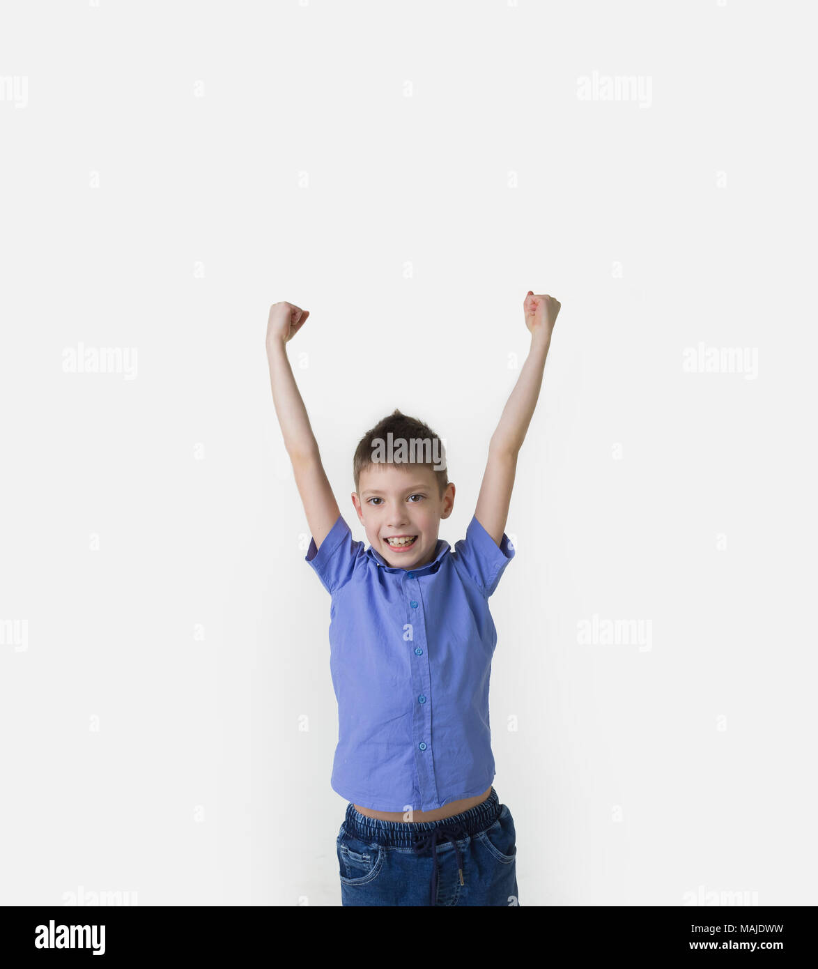 The studio shot of a handsome young teen boy winning over white ...