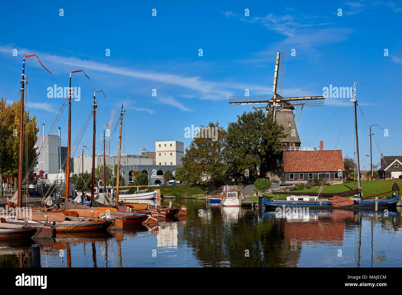 Traditional Dutch Sailing Tjalk, Windmill, Trees and Buildings in the ...