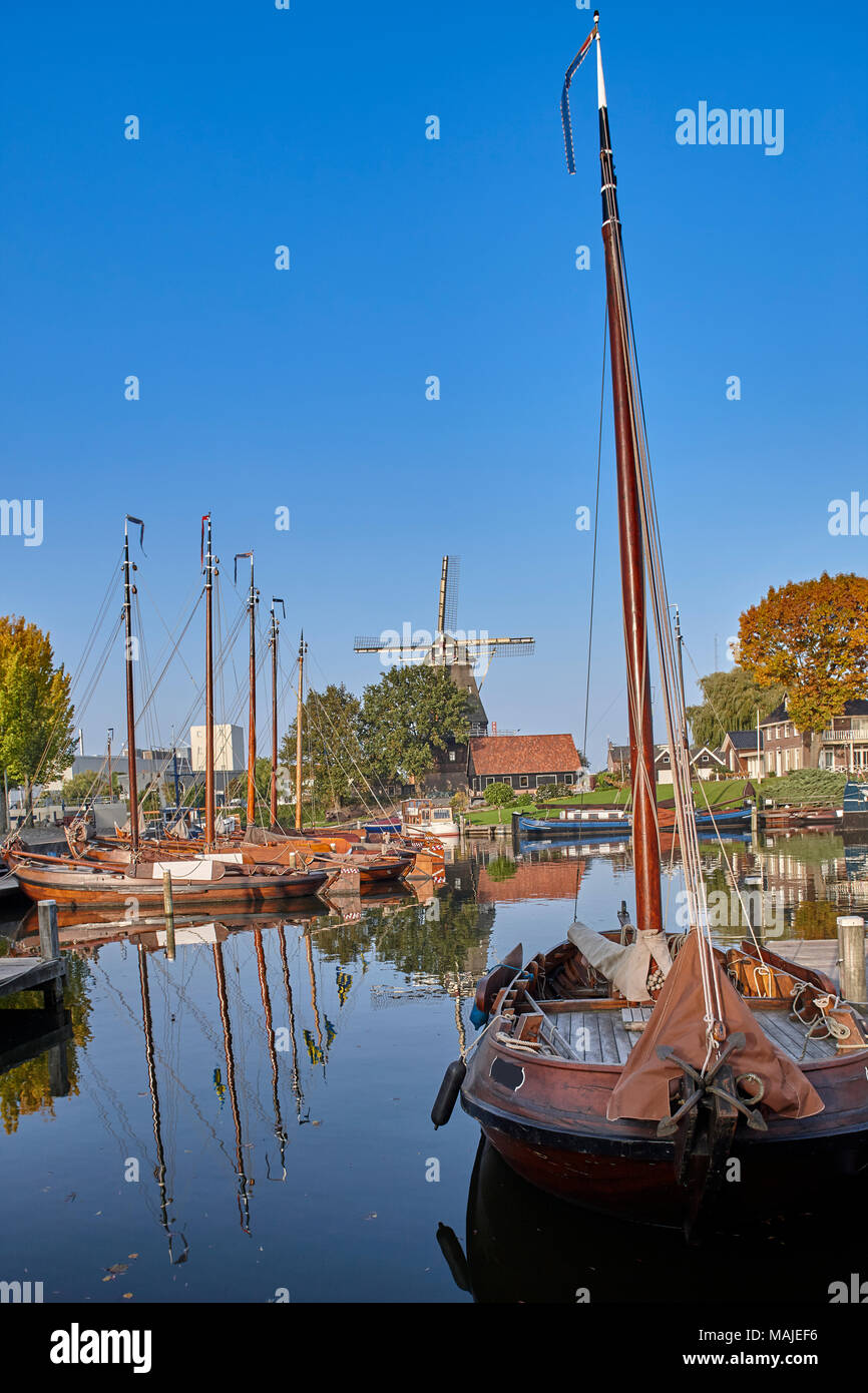Traditional Dutch Sailing Tjalk, Windmill, Trees and Buildings in the ...