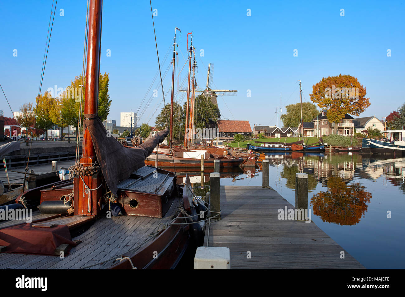Traditional Dutch Sailing Tjalk, Windmill, Trees and Buildings in the ...