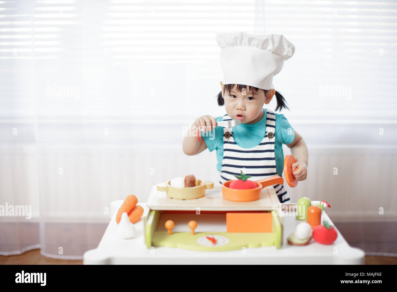 baby girl pretend play food toy Stock Photo - Alamy