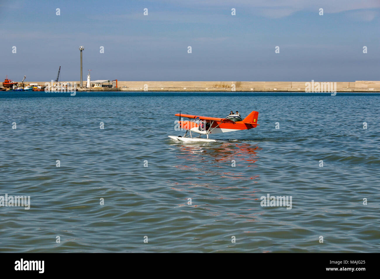 A small seaplane arriving in the port at Palermo, Italy, with an ...