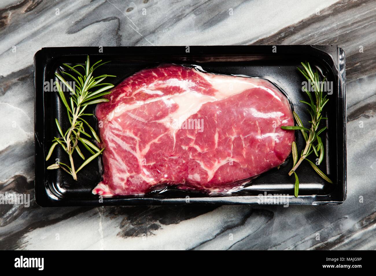 Raw steak in an airtight packaging Stock Photo - Alamy