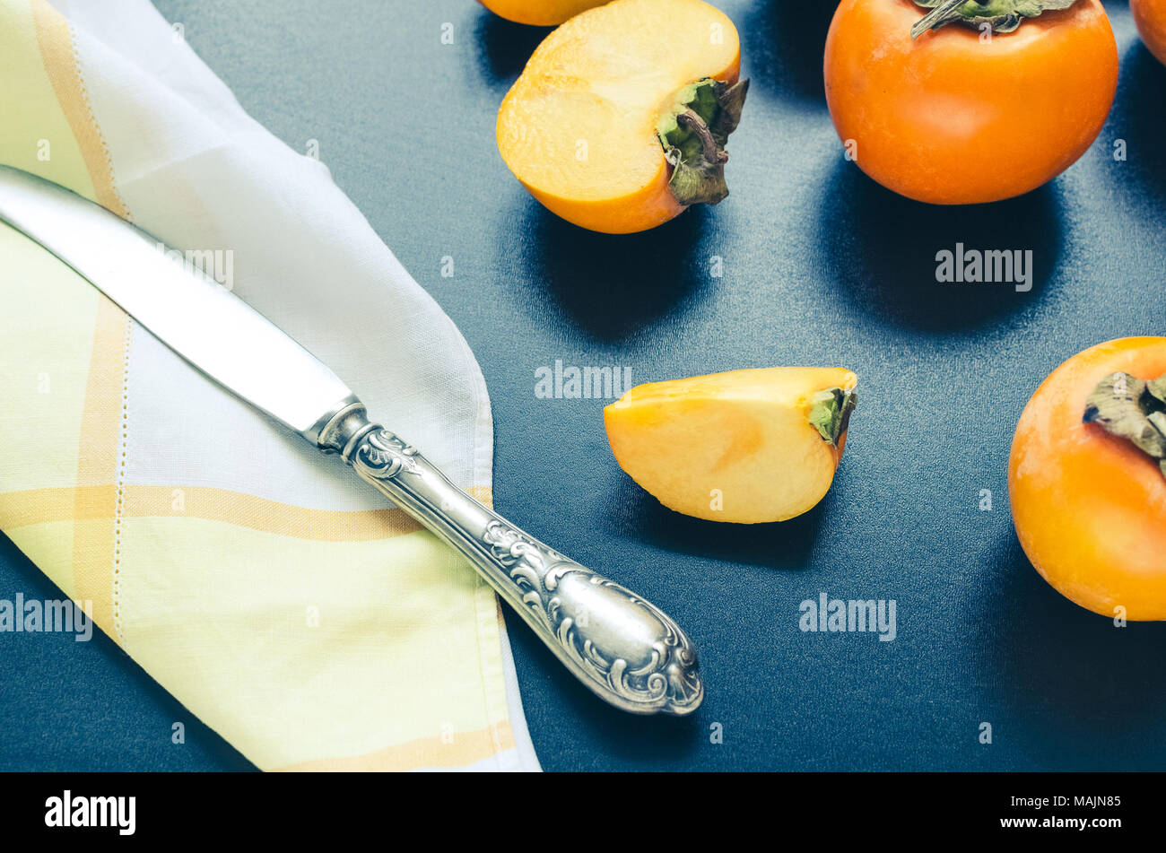 Slice of ripe delicious fresh persimmon kaki fruit with knife and ...