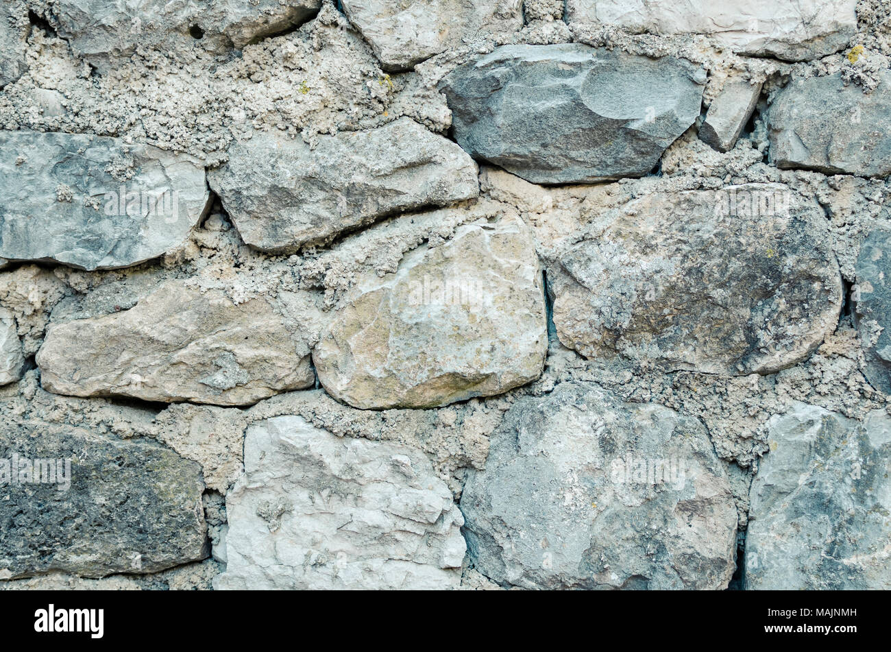 Background of stone wall texture. Neatly stacked rough cut stone wall ...