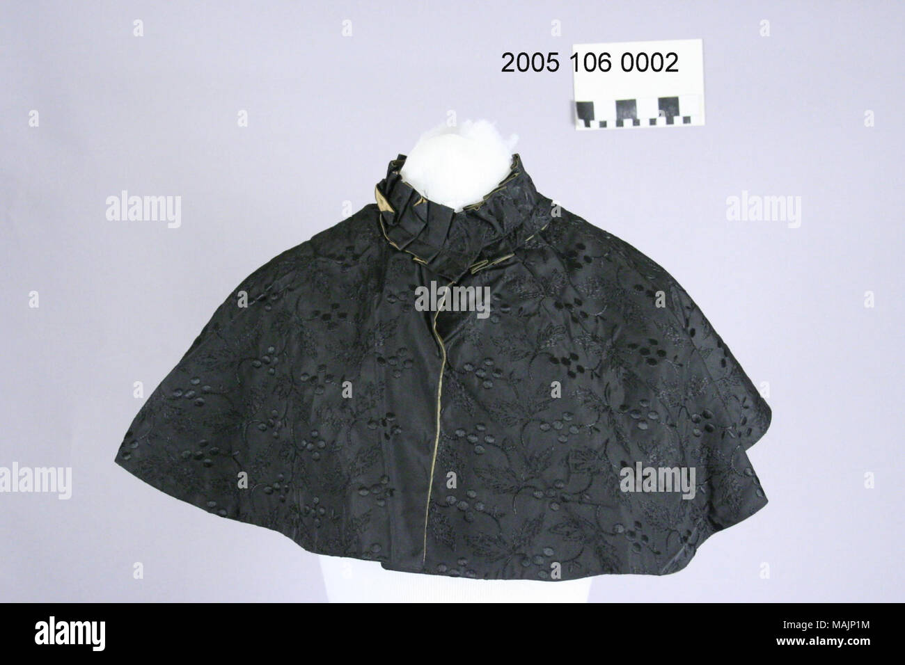 Black embroidered silk capelet with green satin lining and pleated ...