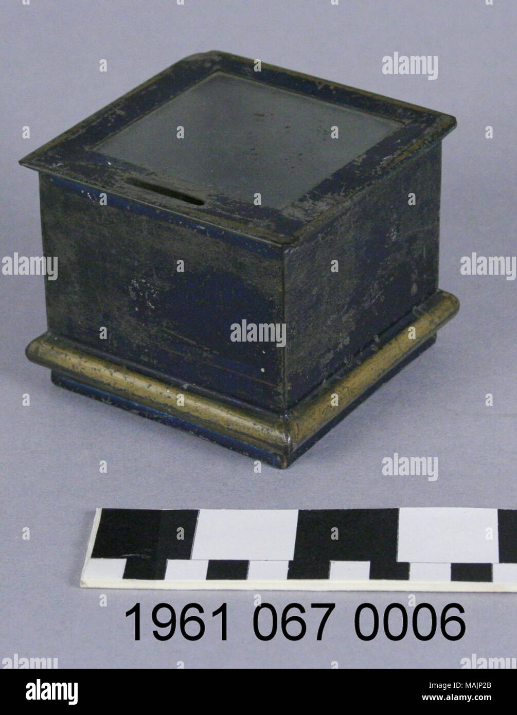 Tin bank in the shape of a blue box with gold trim and glass top. The ...