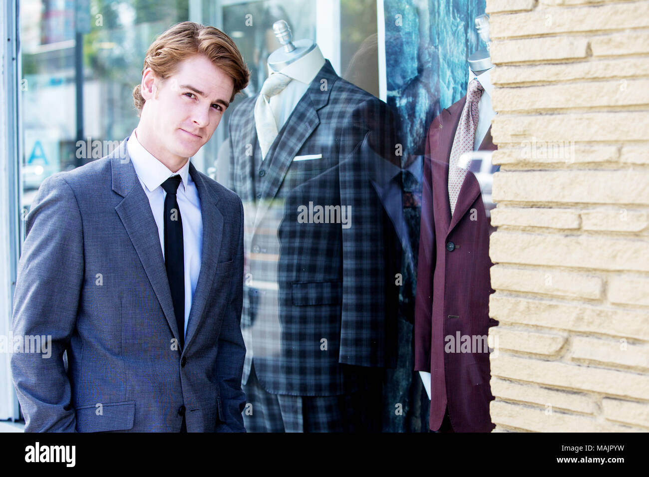portrait of handsome man in suit in front of showcase Stock Photo - Alamy