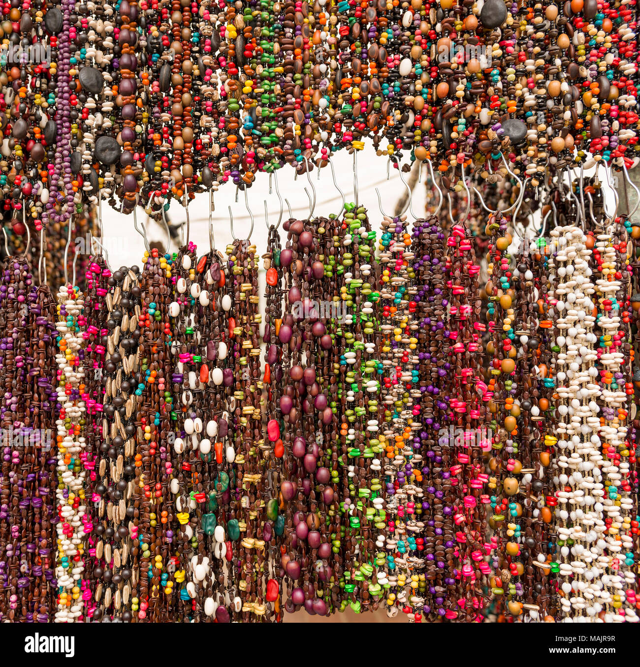 Strings of colorful beads in a local market as a background texture ...