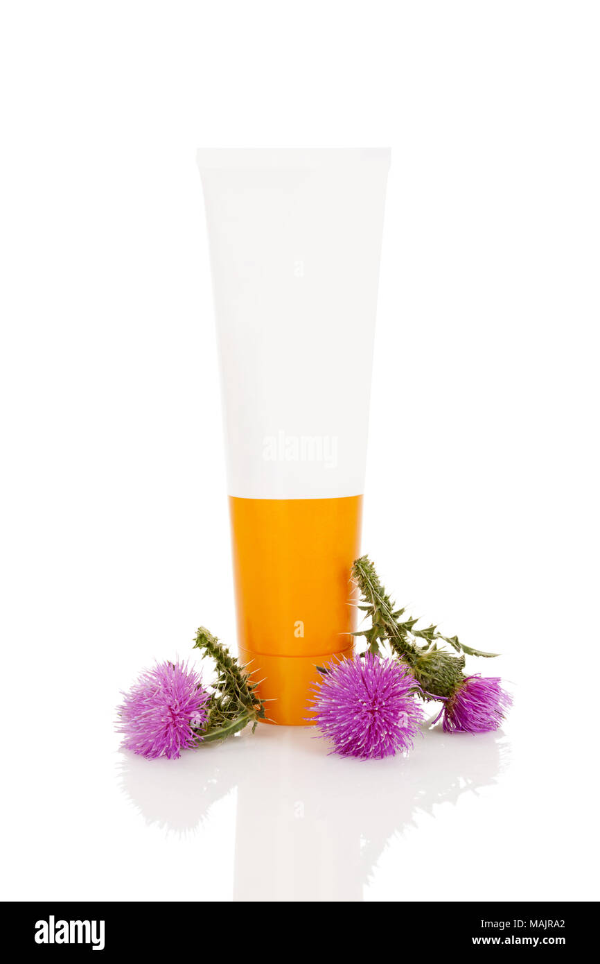Carduus creme in tube with carduus flowers isolated on white background ...