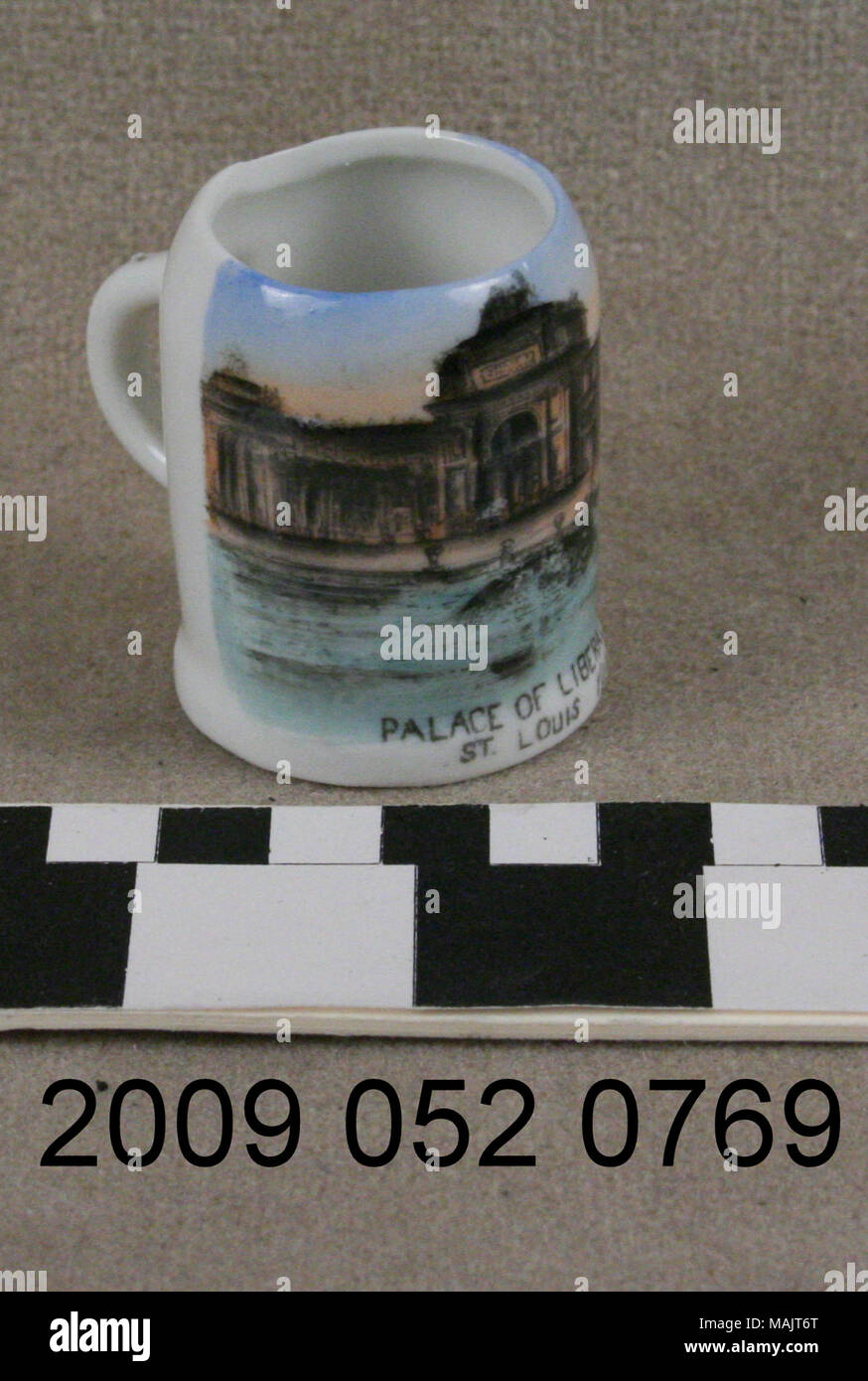 Miniature ceramic stein is white with a large color transfer of the ...