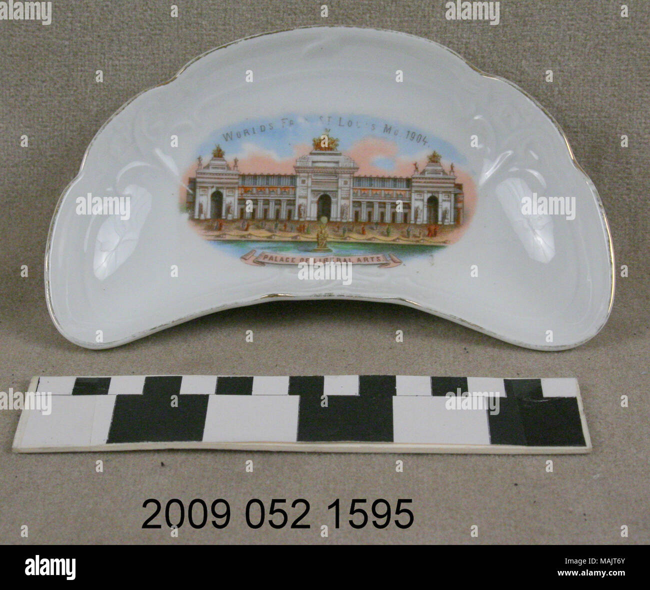 Whtie ceramic bone dish has gilt trim with a large color transfer of ...