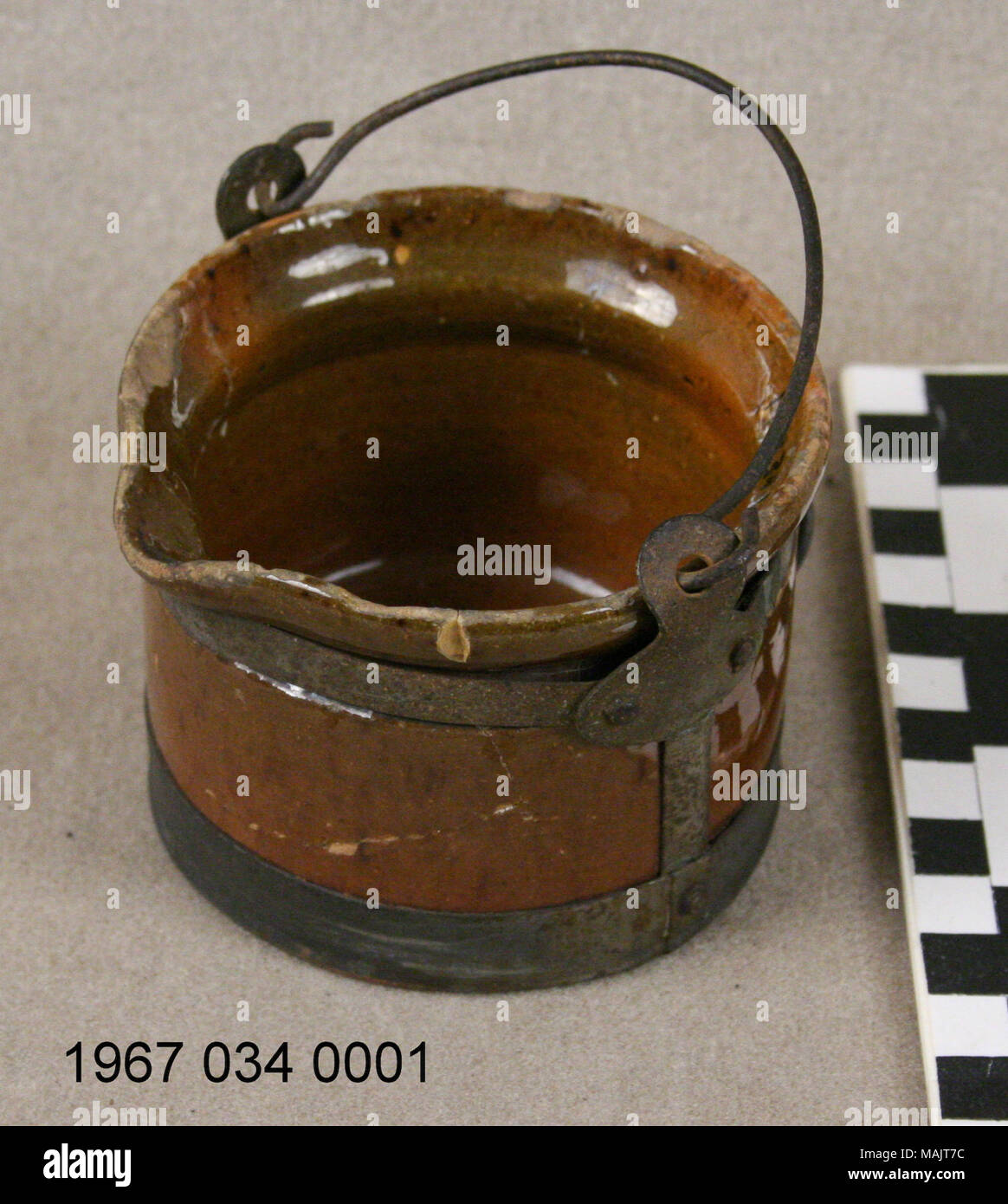 Brown-glazed miniature pottery vessel in the shape of a bucket with a ...
