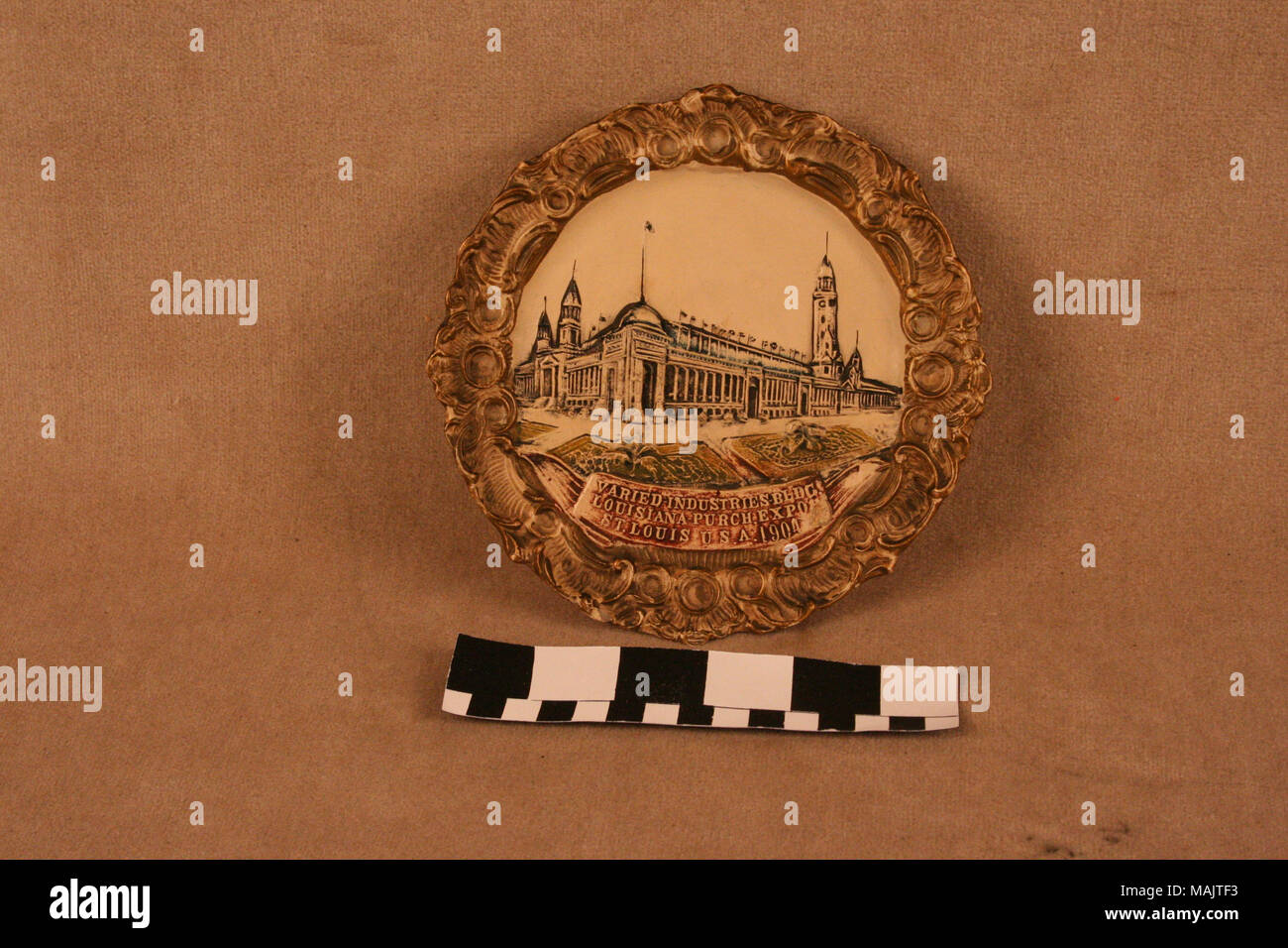 Small round ceramic plaque has a relief view of the Palace of Varied ...