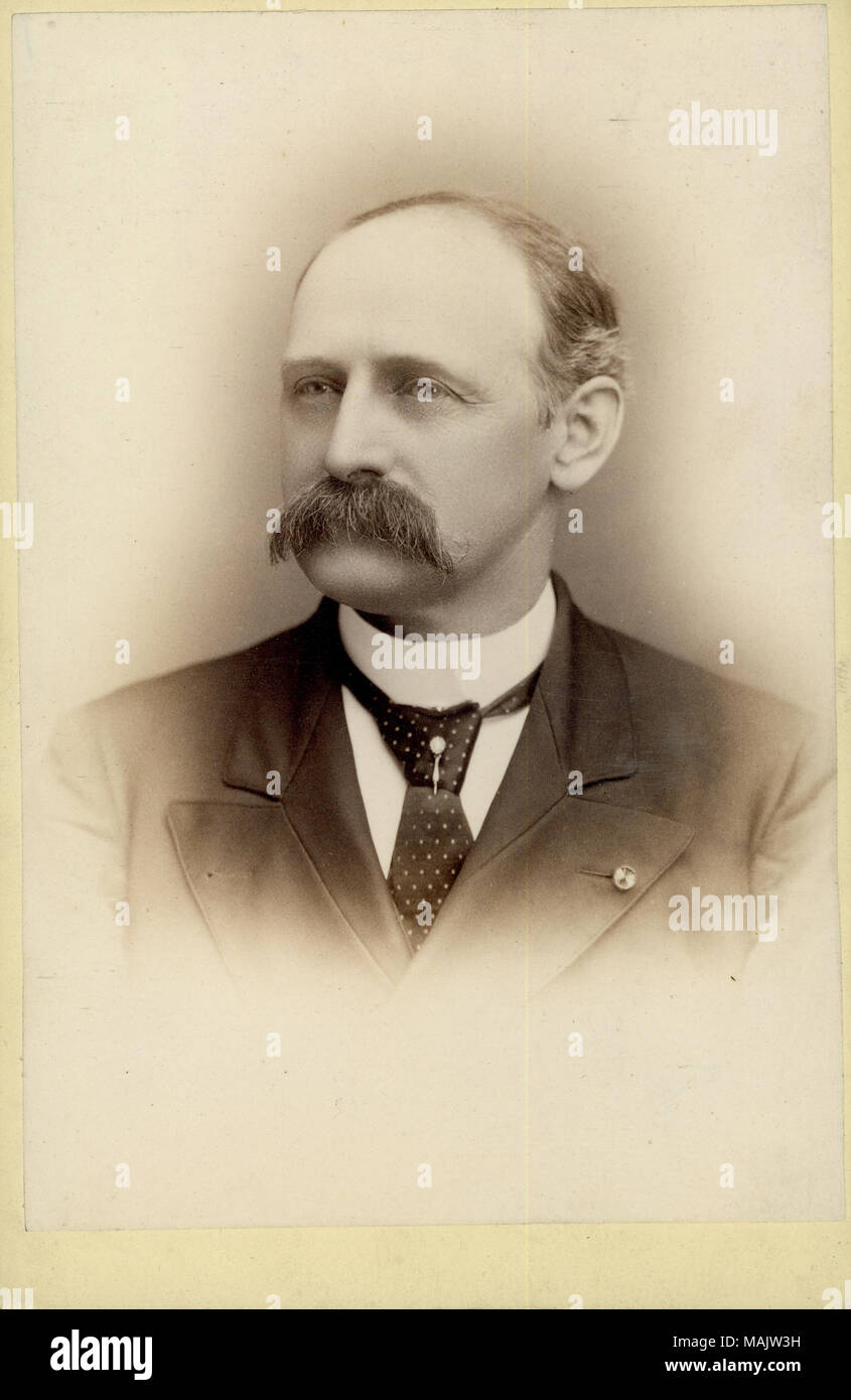 Bust portrait of E. B. Hamilton wearing a suit and tie, with his head ...