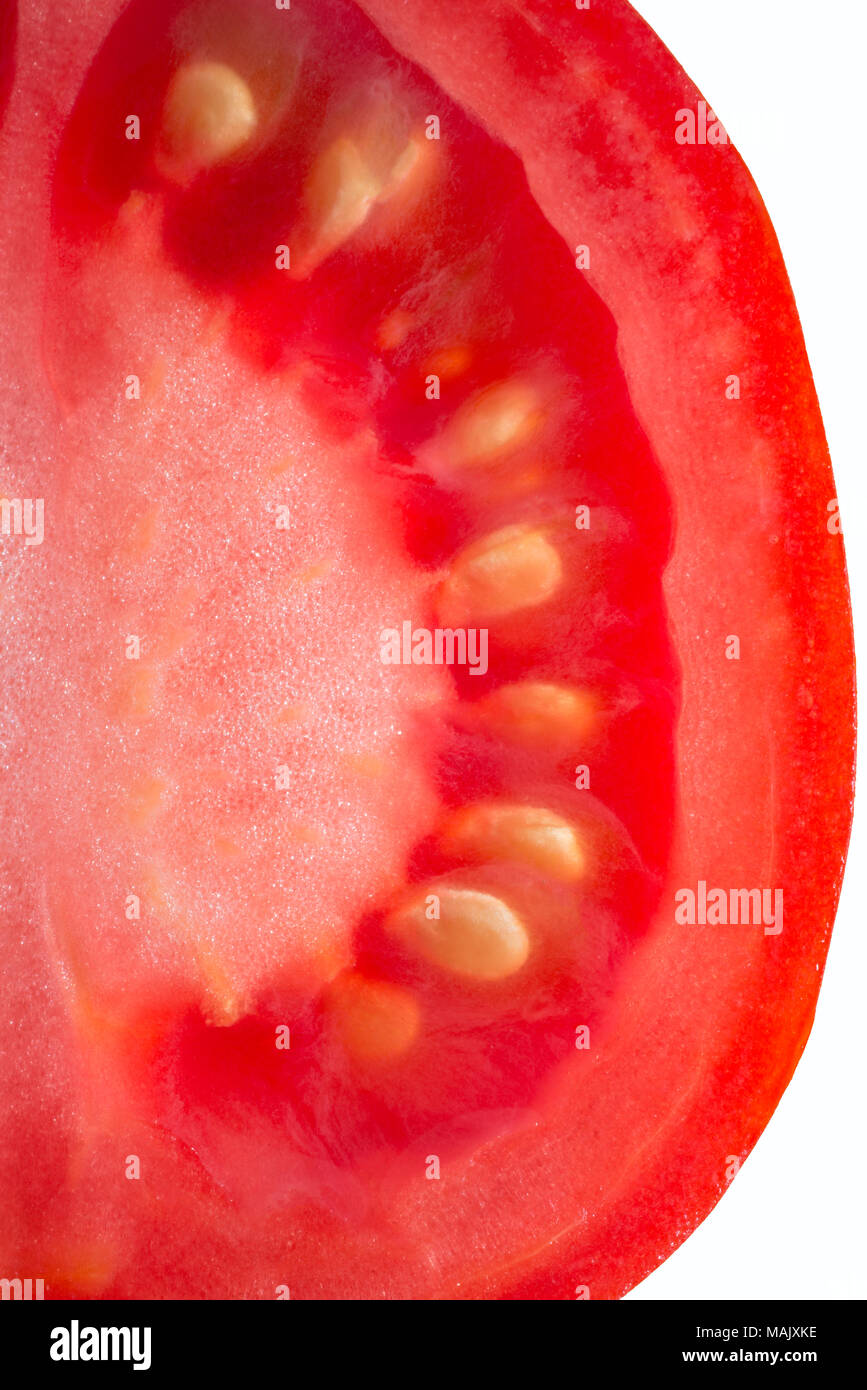 Tomato cut in half on the table macro photo Stock Photo - Alamy