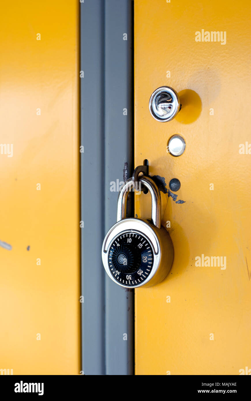 Yellow School Locker with Black Combination Lock - The door of a yellow ...