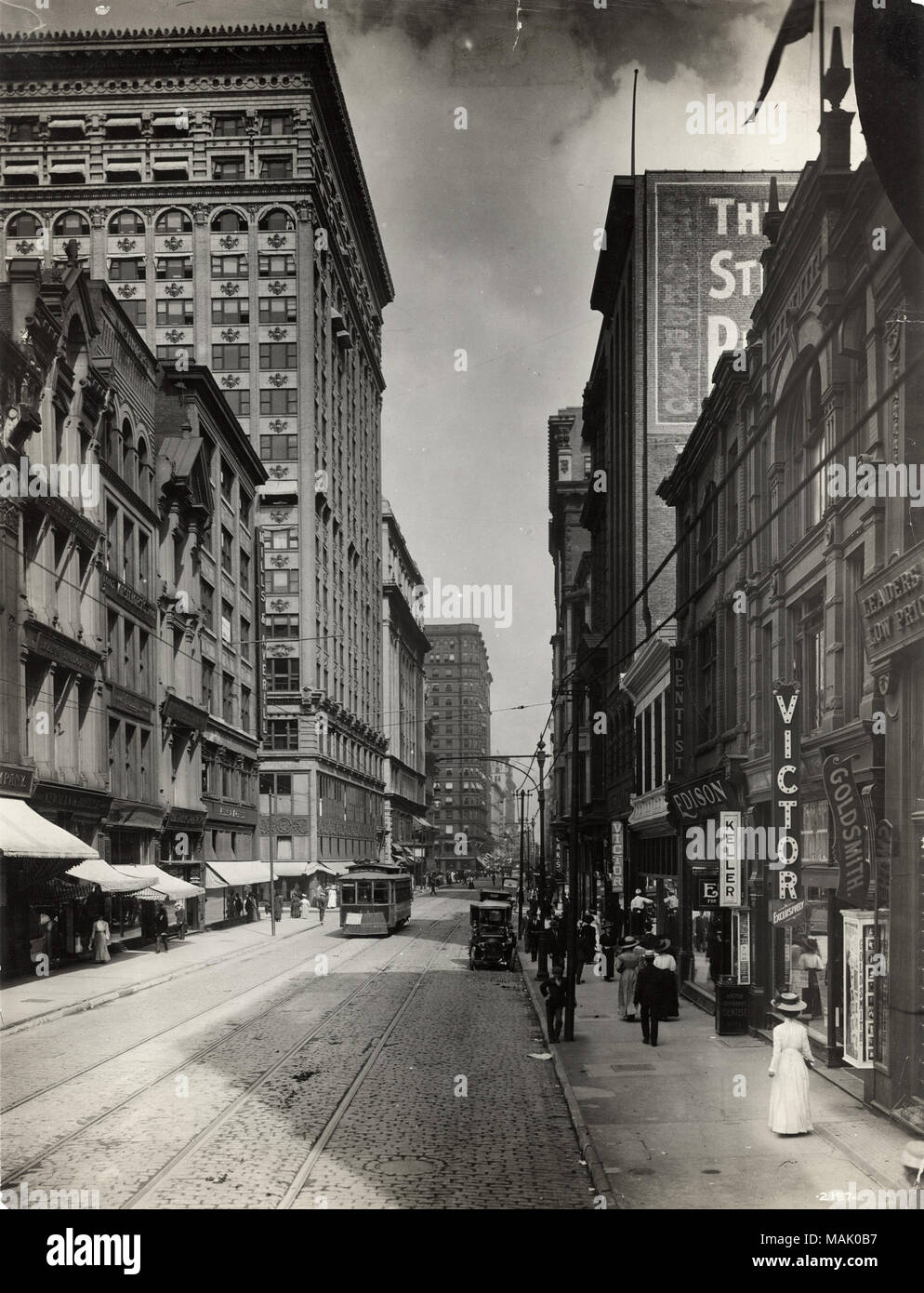Olive Street looking east from Eleventh Street. Businesses pictured are ...