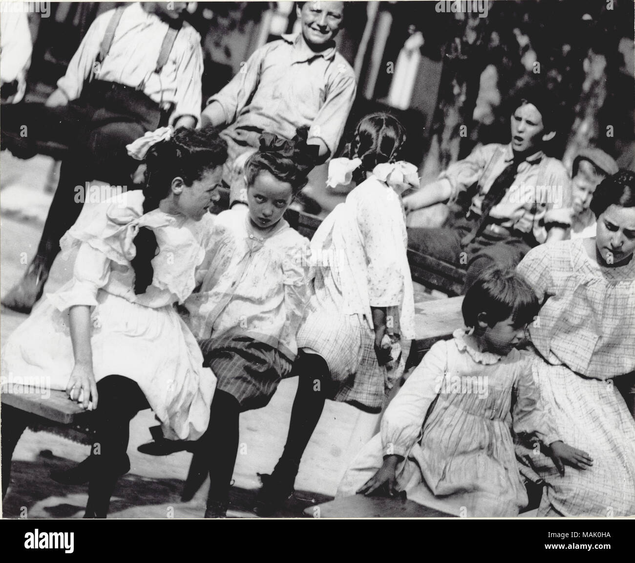 Title: A group of children playing on the teeter-totters in an ...