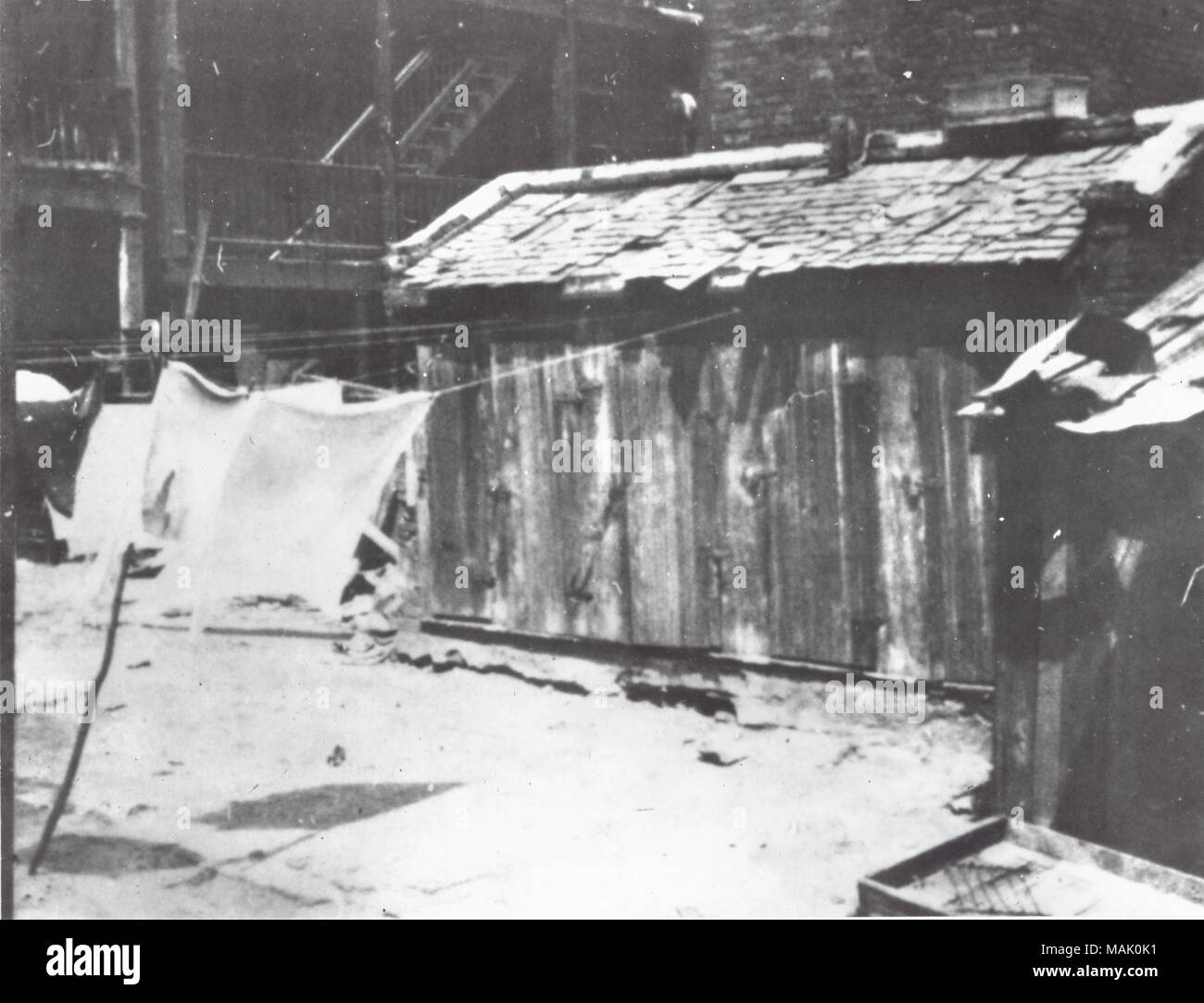 Title: '80 People use these five vaults.' Image of an outhouse from a ...