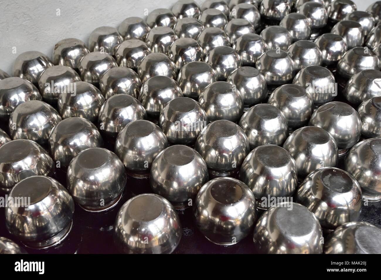 Rows of silver prayer containers Stock Photo - Alamy