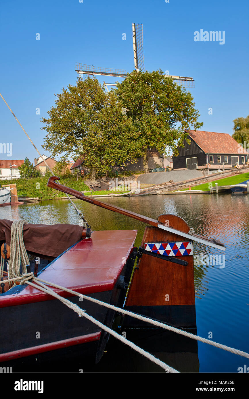 Traditional Dutch Sailing Tjalk windmill, trees and buildings in the ...