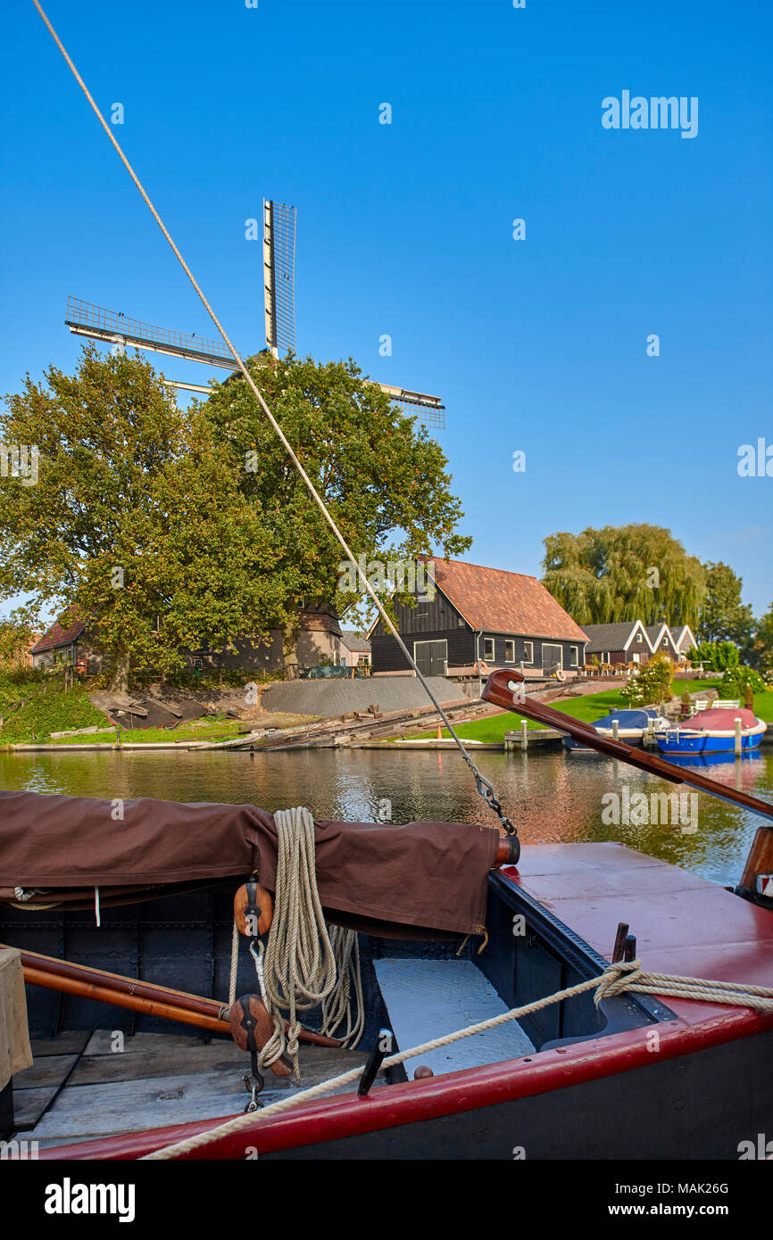 Traditional Dutch Sailing Tjalk windmill, trees and buildings in the ...