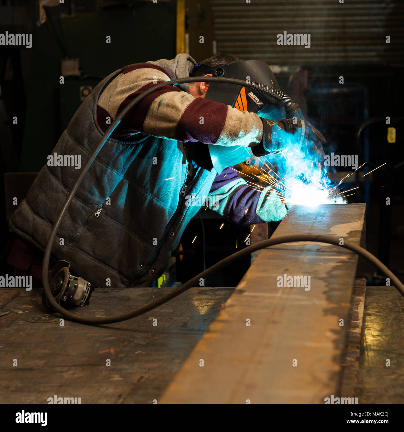 Welder arc welding steel frame Stock Photo - Alamy