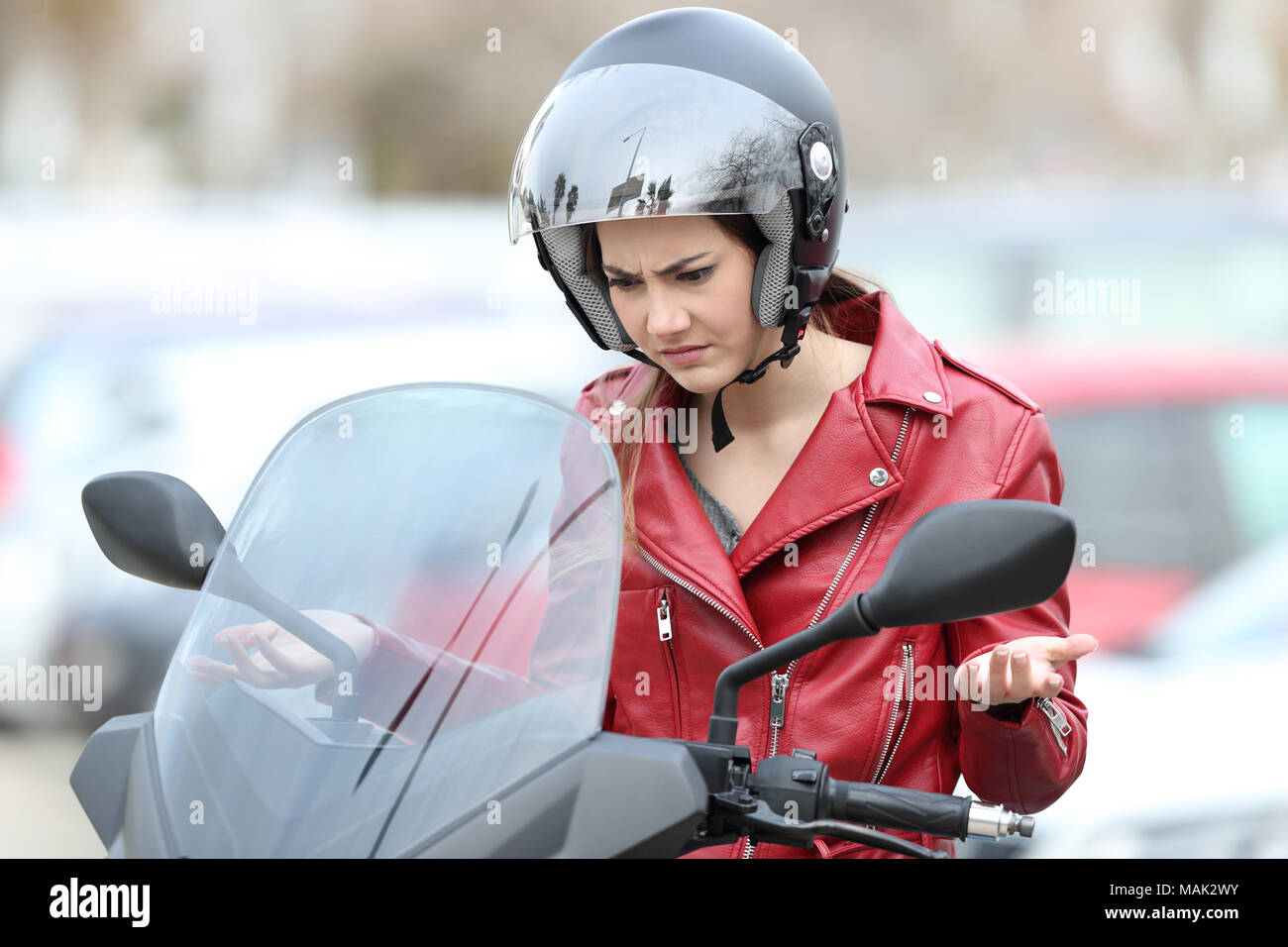Angry biker on a broken down motorbike on the street Stock Photo - Alamy