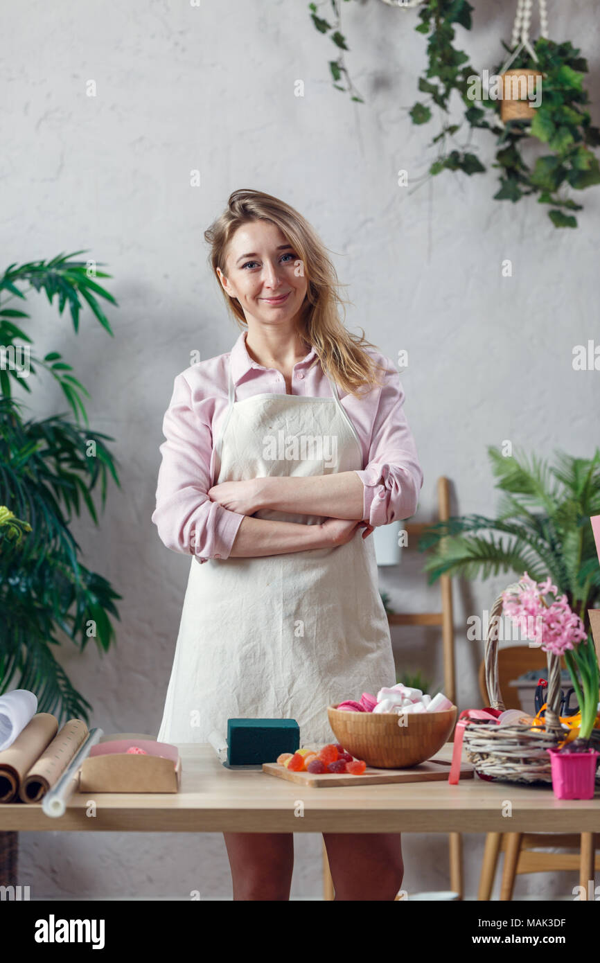 Photo of florist woman in apron at room with flowers Stock Photo - Alamy