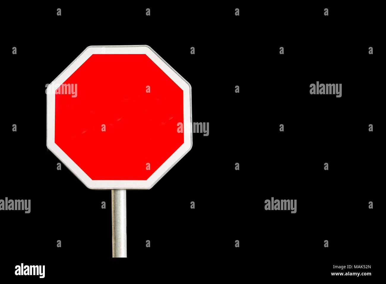 Red road sign on black background Stock Photo - Alamy