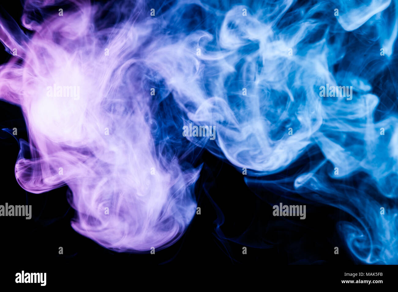 Colorful blue smoke on a black isolated background. Background from the ...