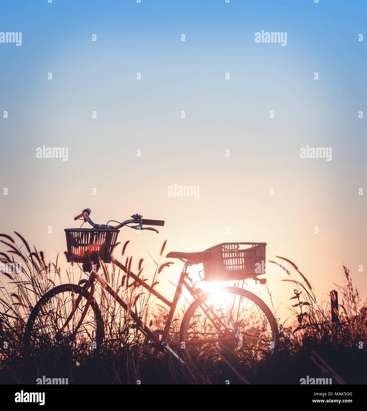 beautiful landscape image with Bicycle at sunset on glass field meadow ...