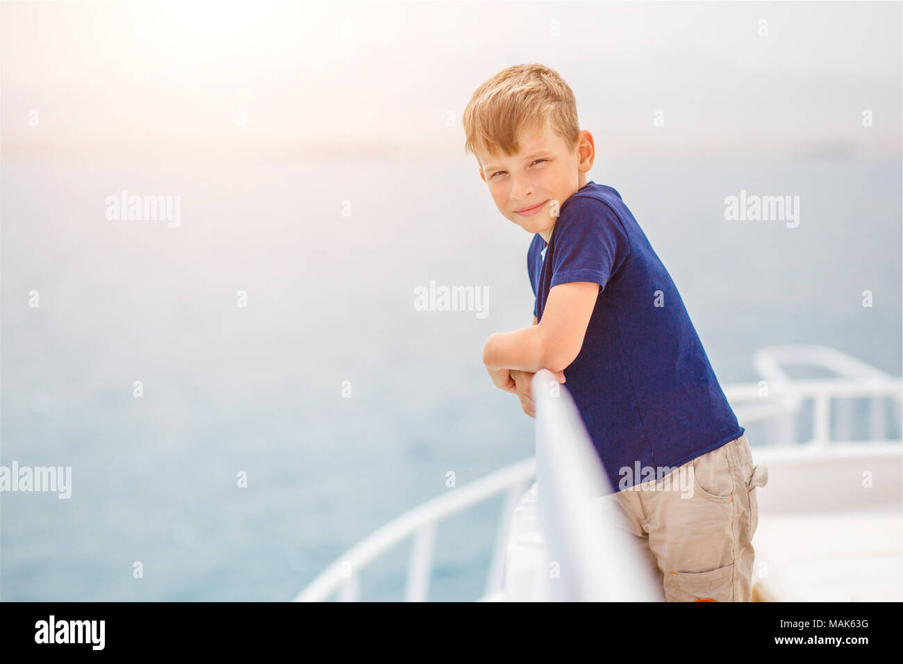 Small boy enjoying summer vacation on sea. Happy boy on yacht cruise ...