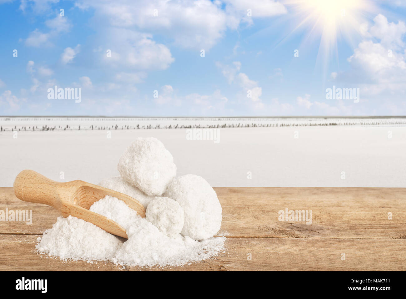 salt and scoop on table. Lumps of salt with salty lake in the ...