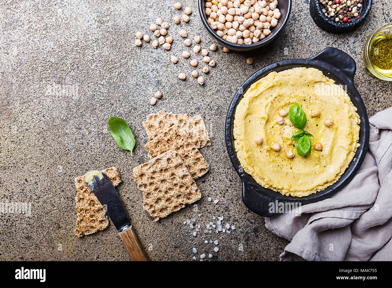 Healthy Homemade Creamy Hummus with Olive Oil over stone background ...