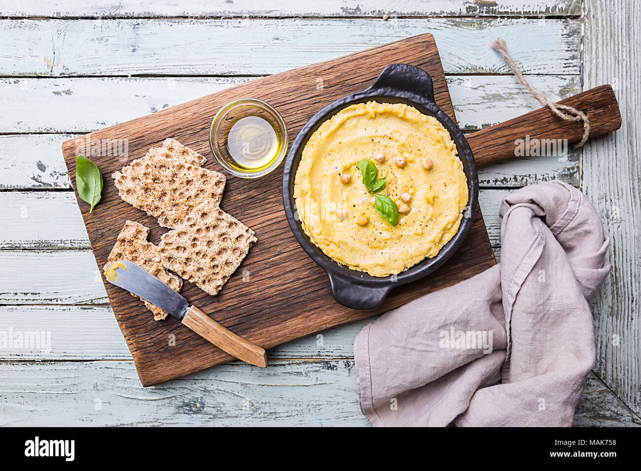 Healthy Homemade Creamy Hummus with Olive Oil over rustic wooden ...